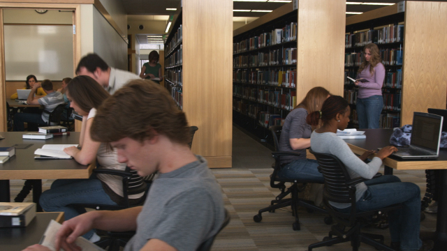Clip of students in a library studying